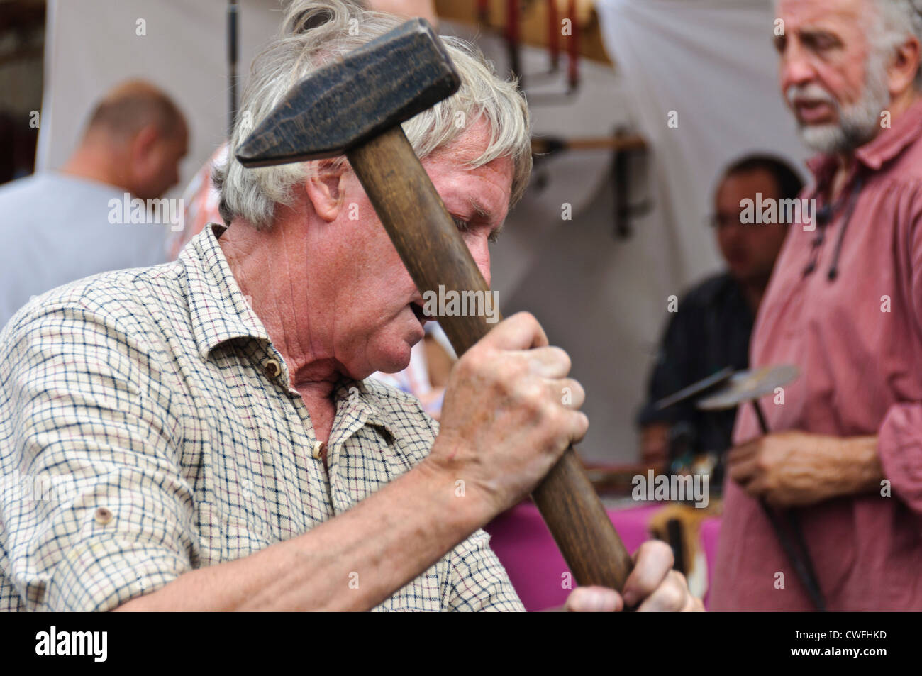 Blacksmith sways a big sledgehammer at a medieval market, Bad Wimpfen ...