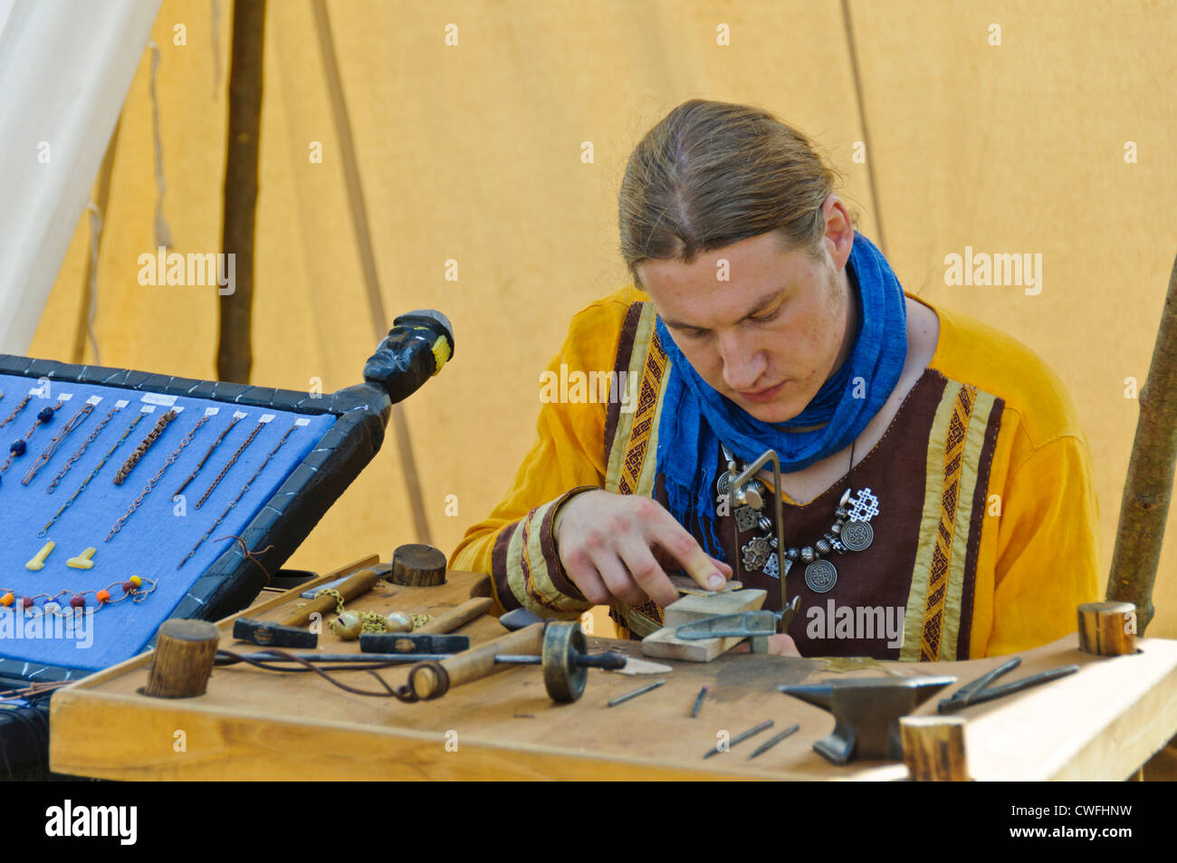 Male craftsman shows ancient handcraft at an medieval market ...