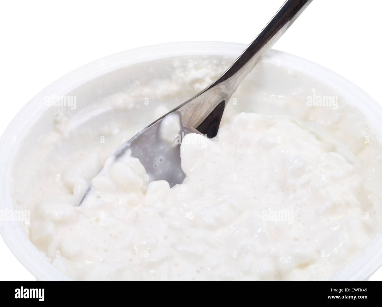 metal spoon in tub of cottage cheese isolated on white background Stock ...