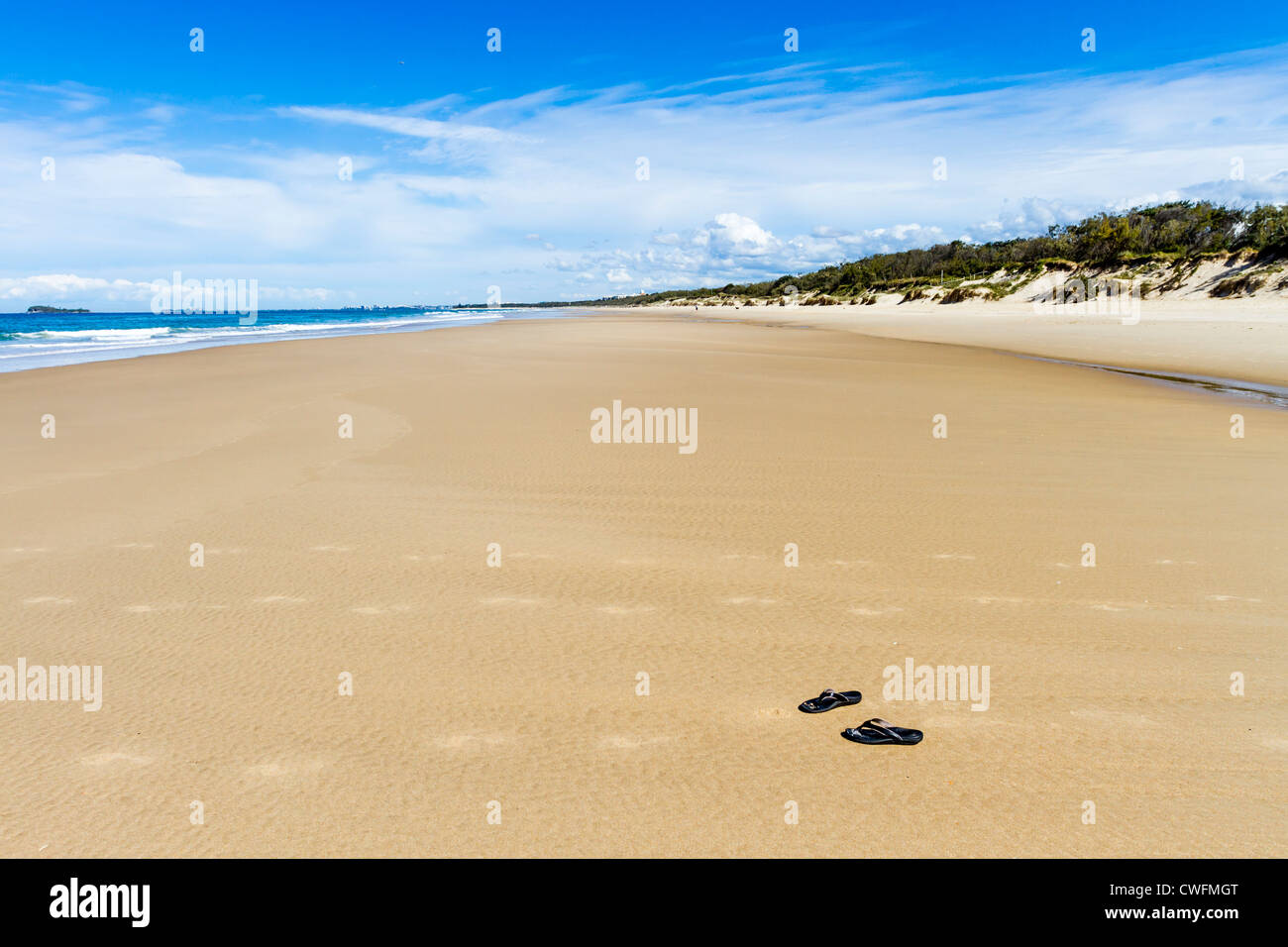 Deserted lonely beach with thongs at Marcoola, Sunshine Coast ...
