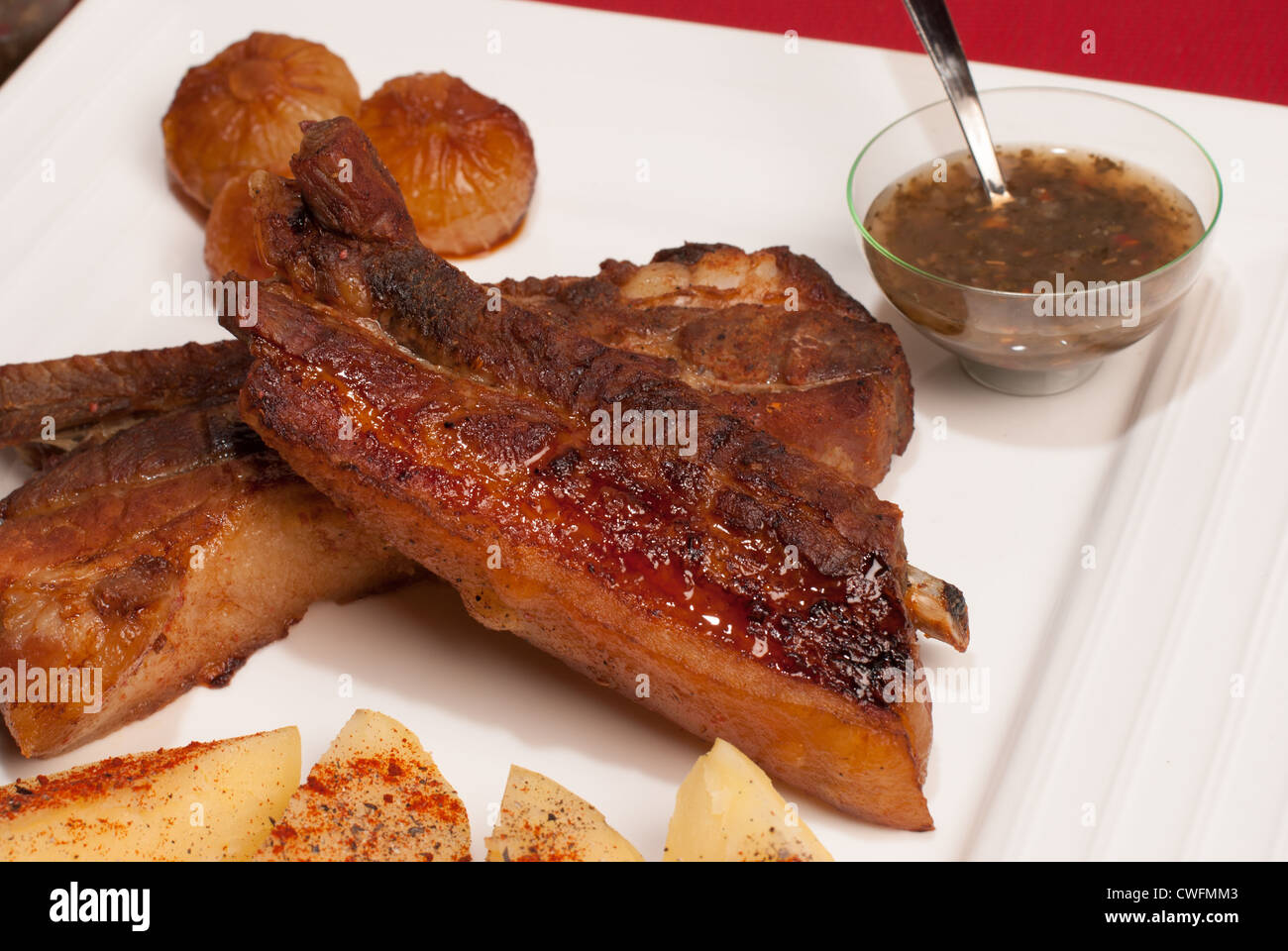 Grilled caramelized pork ribs served with garnish and Argentinian ...