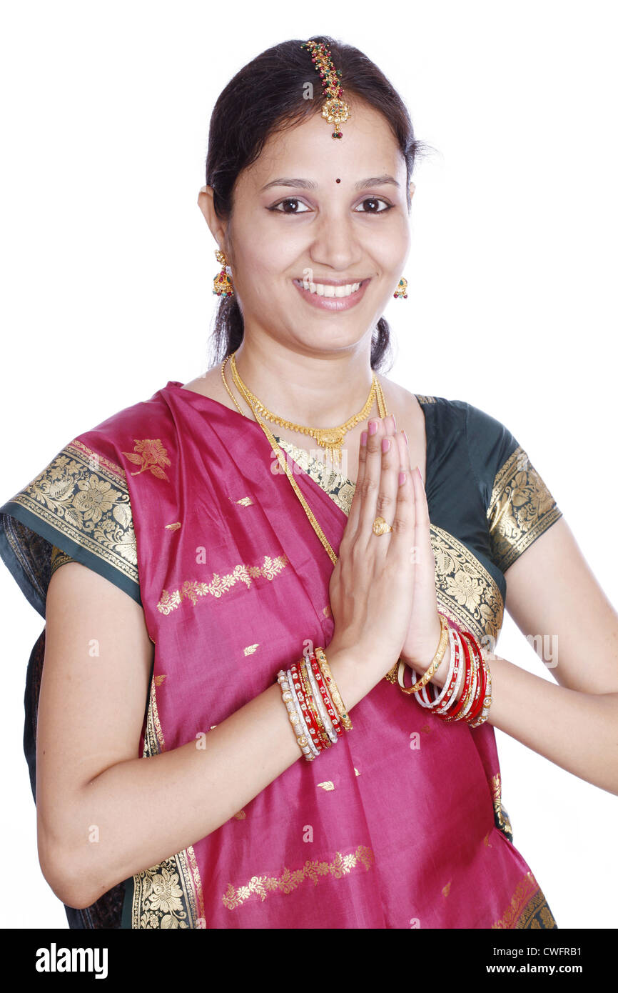 Traditional Indian girl holding hands in prayer position Stock Photo ...