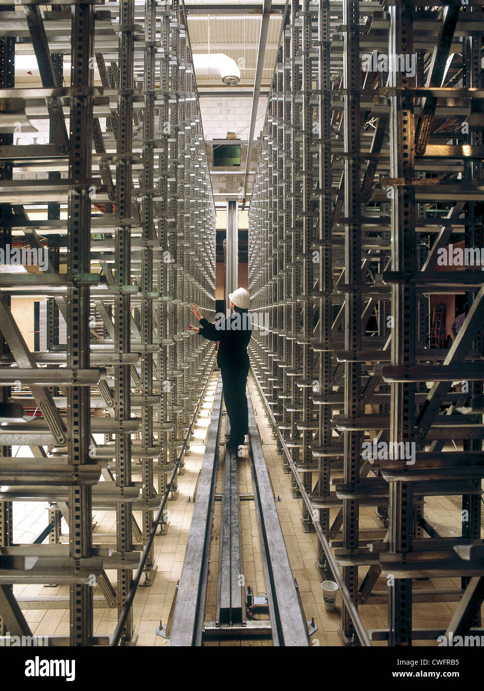 Worker inspecting racking at a warehouse building site Stock Photo - Alamy