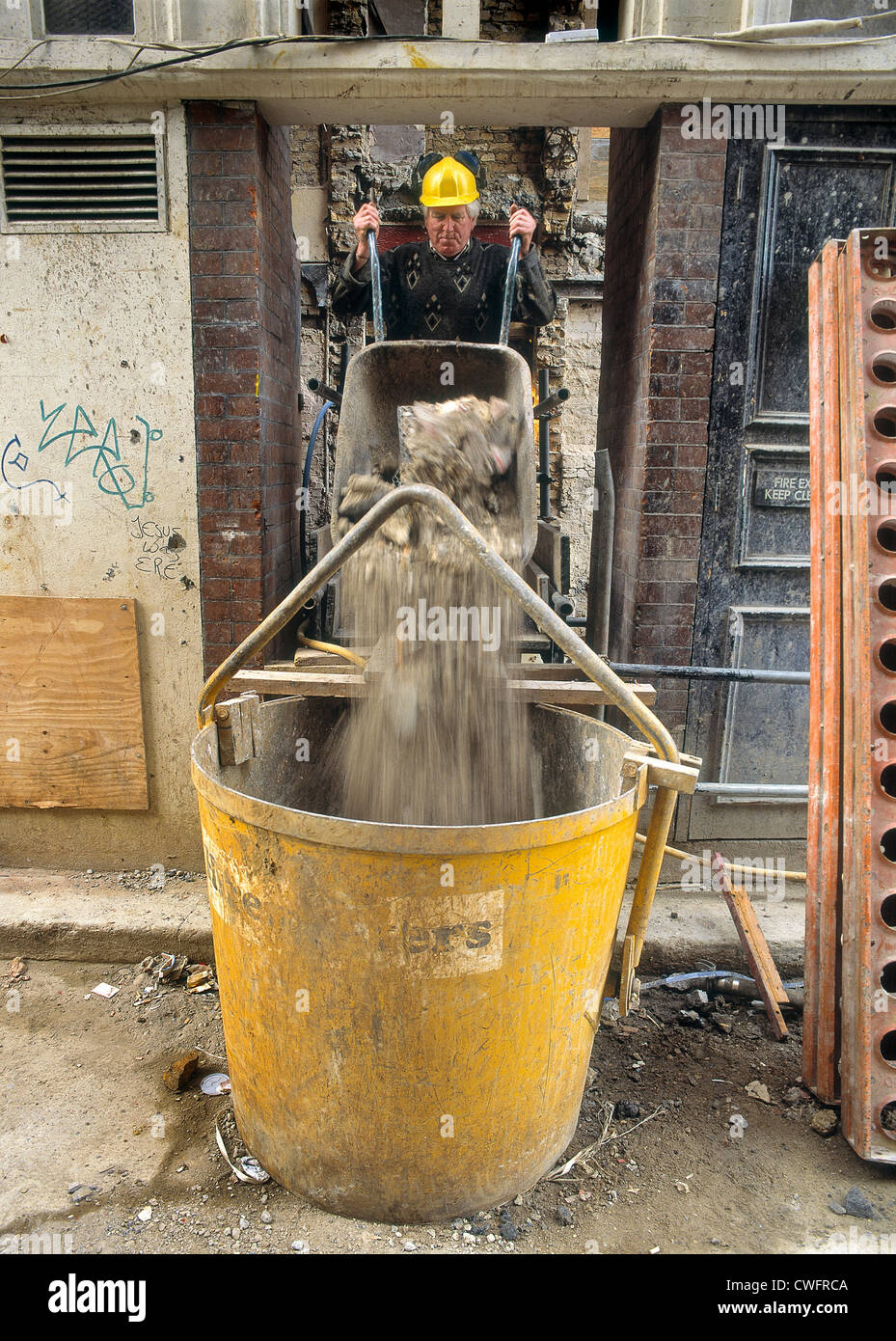 Site worker disposing of waste Stock Photo - Alamy