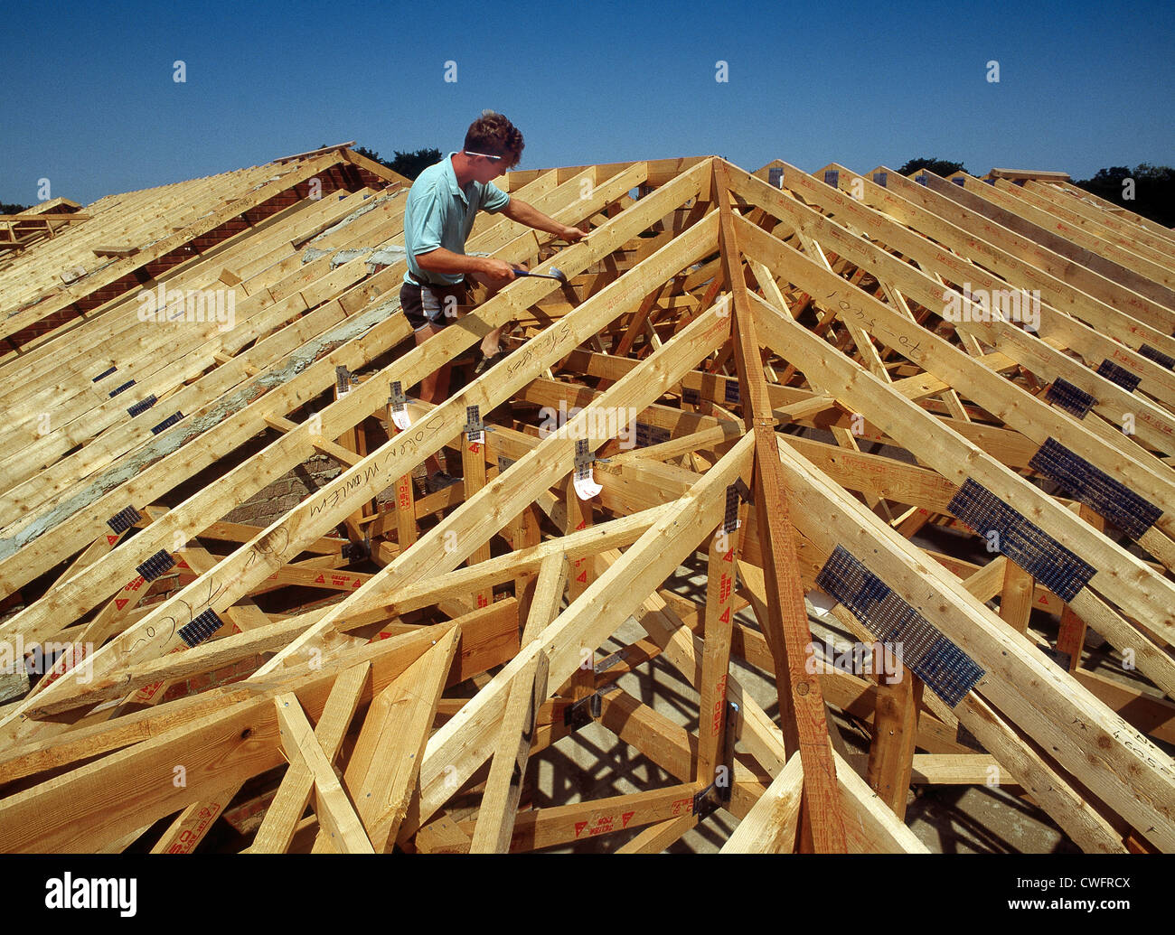 Carpenter working on a self-build housing project in the UK Stock Photo ...