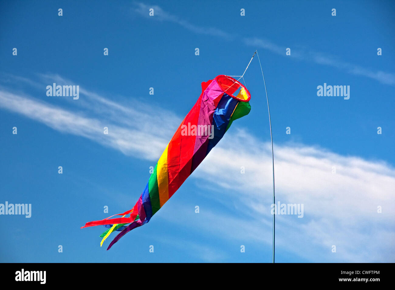 Colourful windsock against blue sky with clouds Stock Photo - Alamy