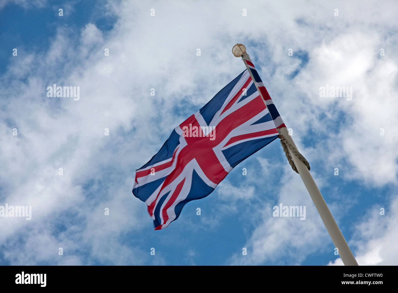 Union flag flying against a cloudy sky Stock Photo - Alamy