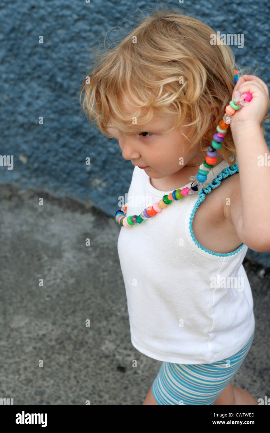 Little girl plays with a chain Stock Photo - Alamy
