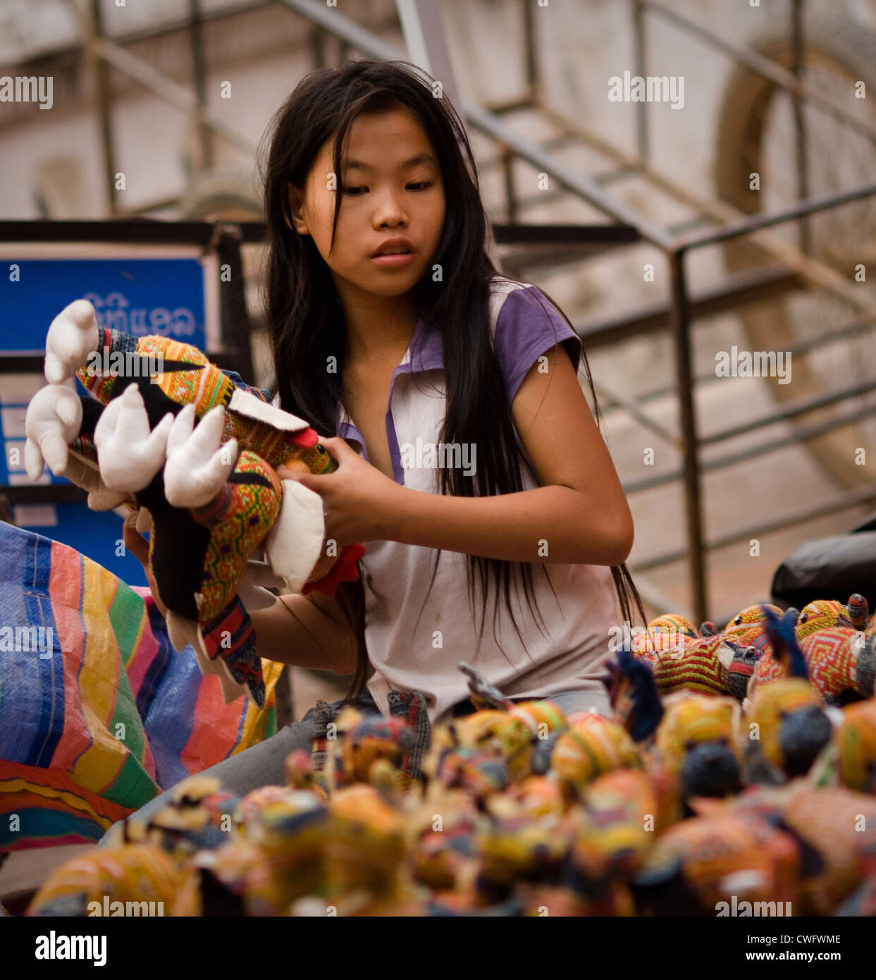 Young girl selling fluffy animals in Luang Prabang night market, Laos ...