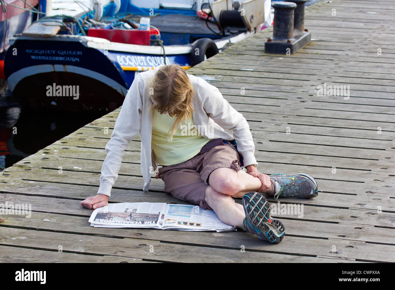 Whitby - north Yorkshire during the Regatta - a woman reading a ...