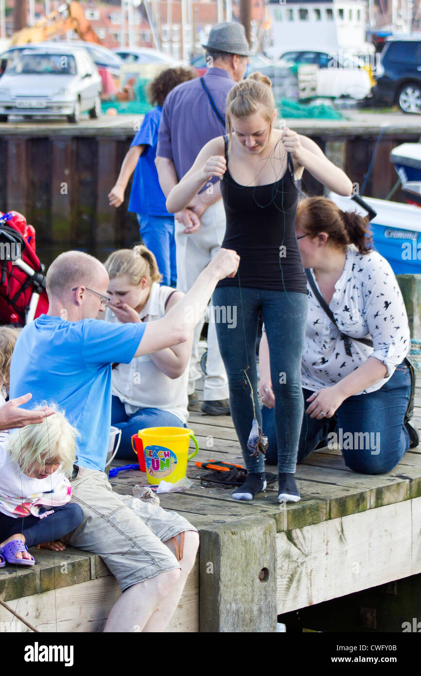 A young female Catching crabs at Whitby 2012 Stock Photo - Alamy