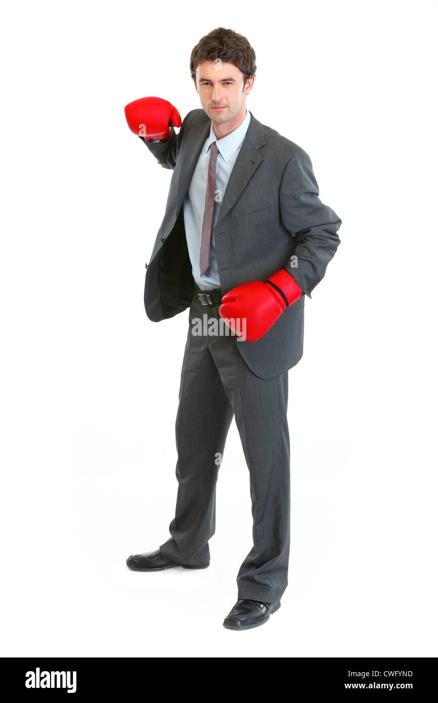 Businessman in boxing gloves swinging arm to strike Stock Photo - Alamy