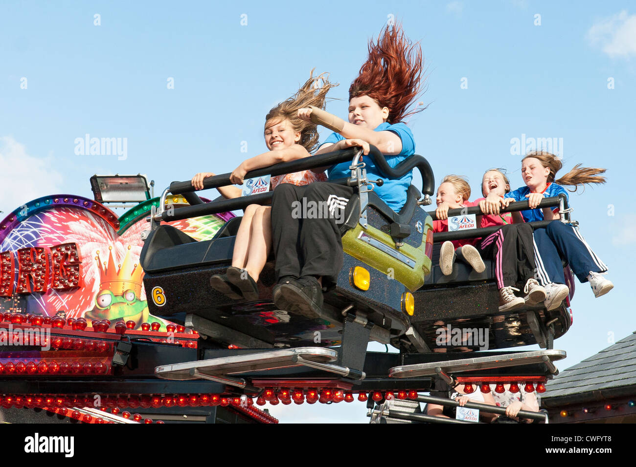 Fairground rides at Whitby Regatta. young girls with their hair ...