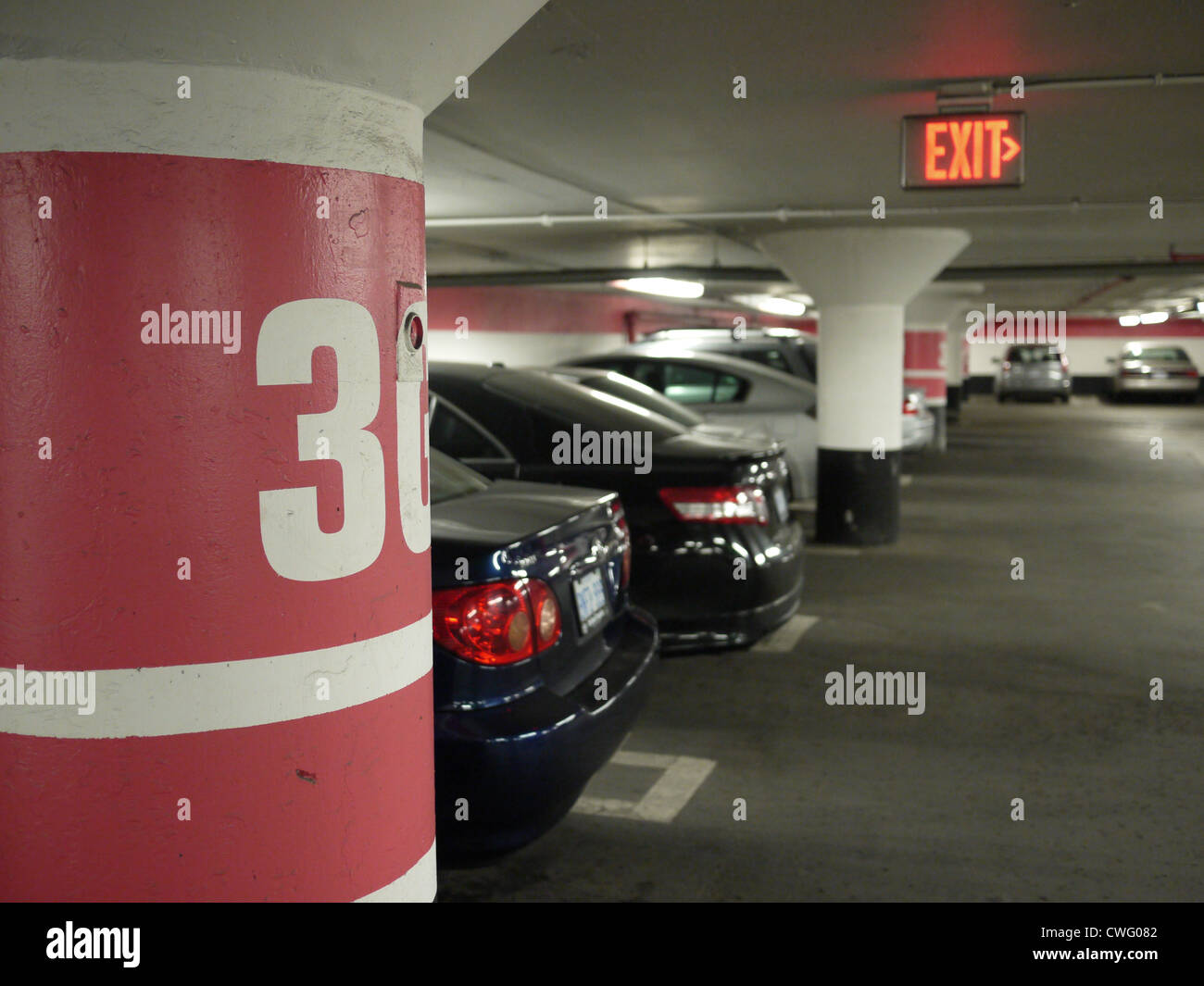 underground parking garage pillar exit sign Stock Photo - Alamy