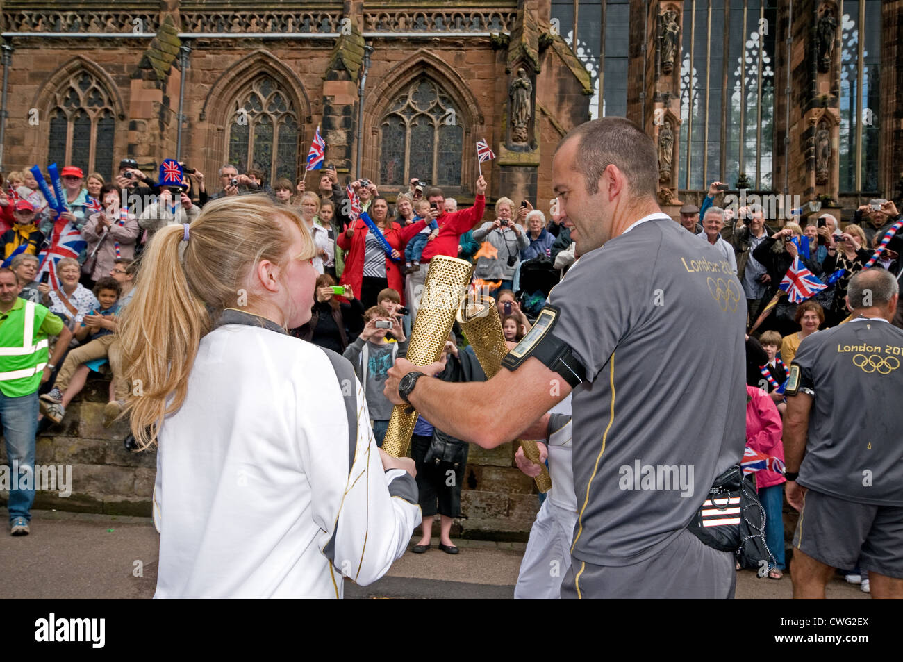 Metropolitan Police Officer Olymic Flame Escort helping the transfer of ...