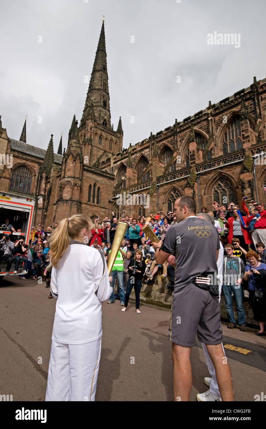 Metropolitan Police Officer Olymic Flame Escort helping the transfer of ...