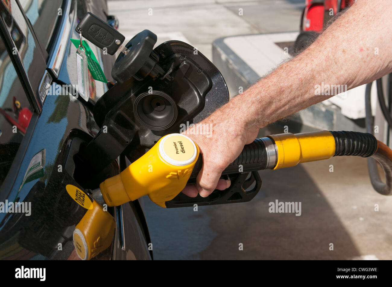 Filling the diesel fuel tank of a Citroen car at a service station ...