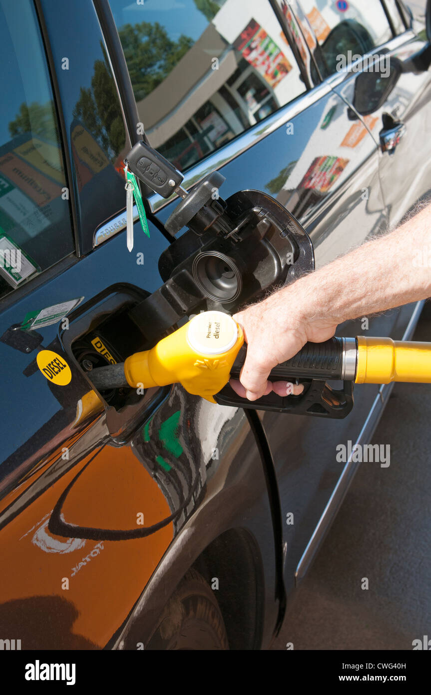 Filling the diesel fuel tank of a Citroen car at a service station ...