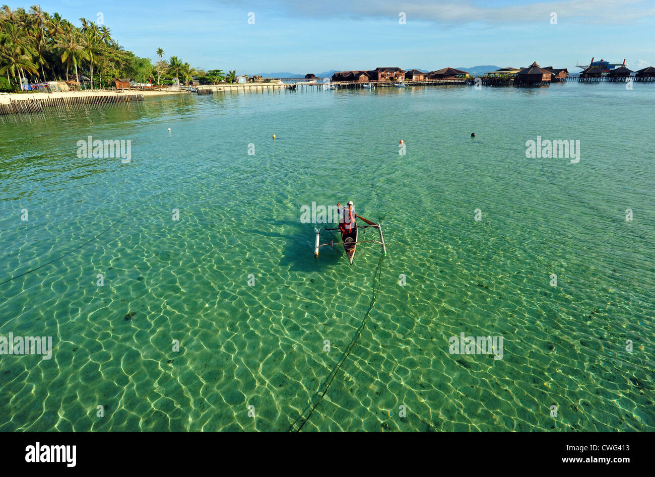 Malaysia, Borneo, Semporna, Mabul, fishermen in canoe in transparent ...