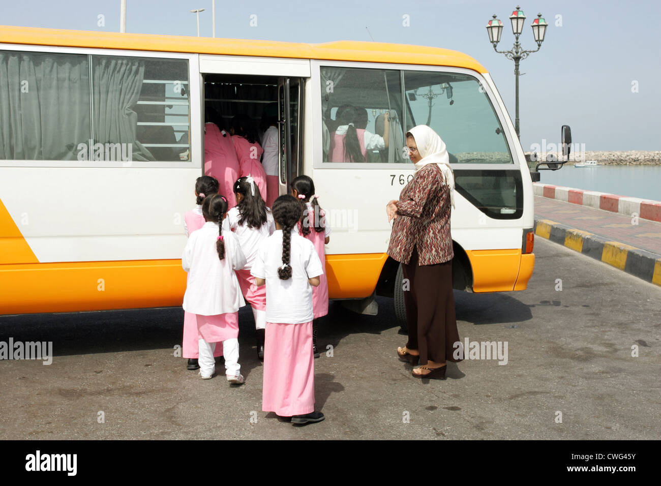 Abu Dhabi, children go into a school bus Stock Photo - Alamy