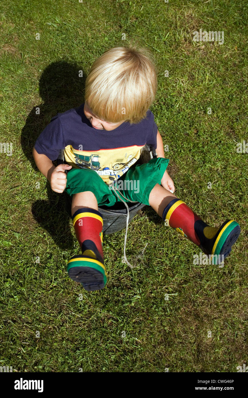 Berlin, a toddler sitting in a bucket Stock Photo - Alamy