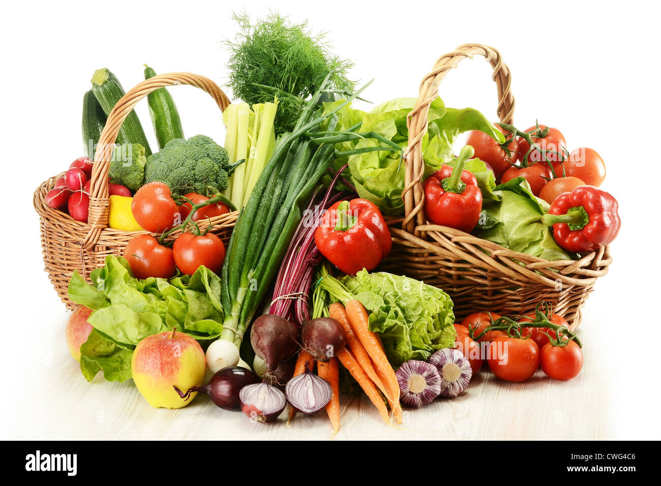 Composition with raw vegetables and wicker basket isolated on white ...