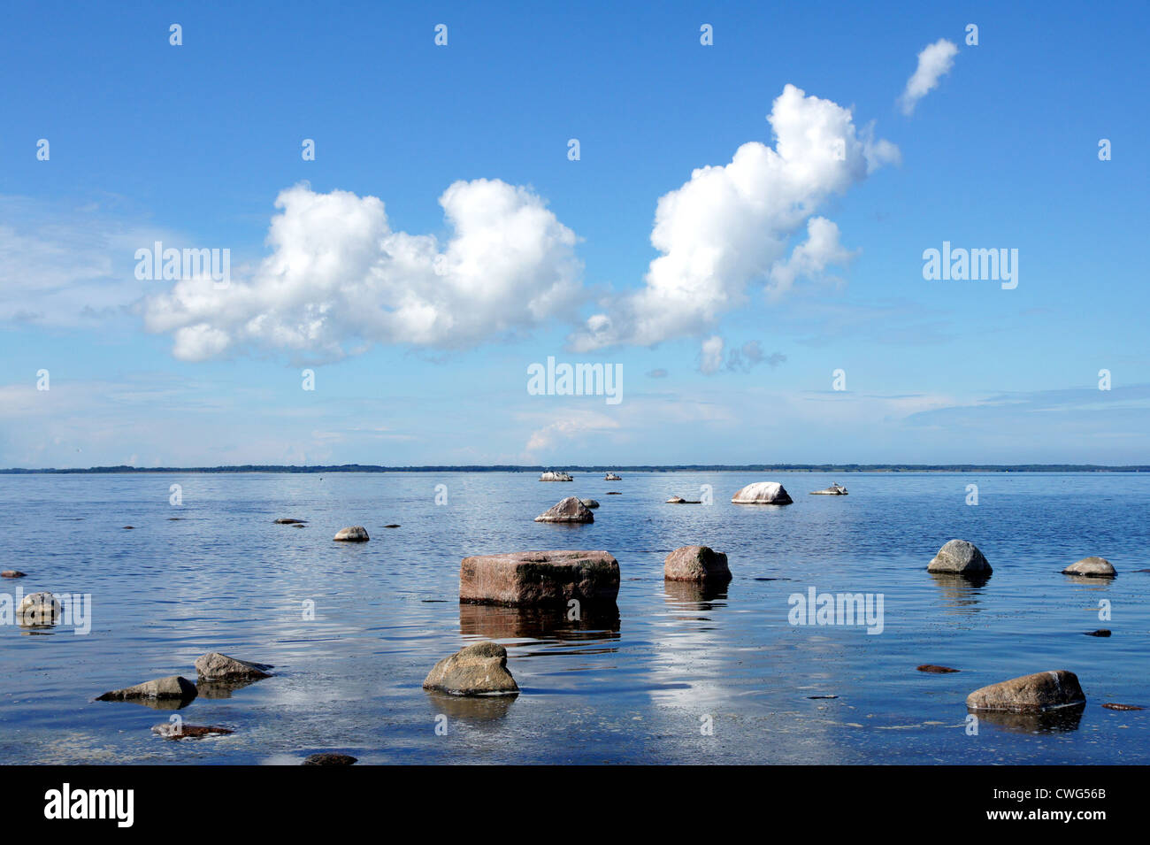 Stones, sea, sky and white clouds Stock Photo - Alamy