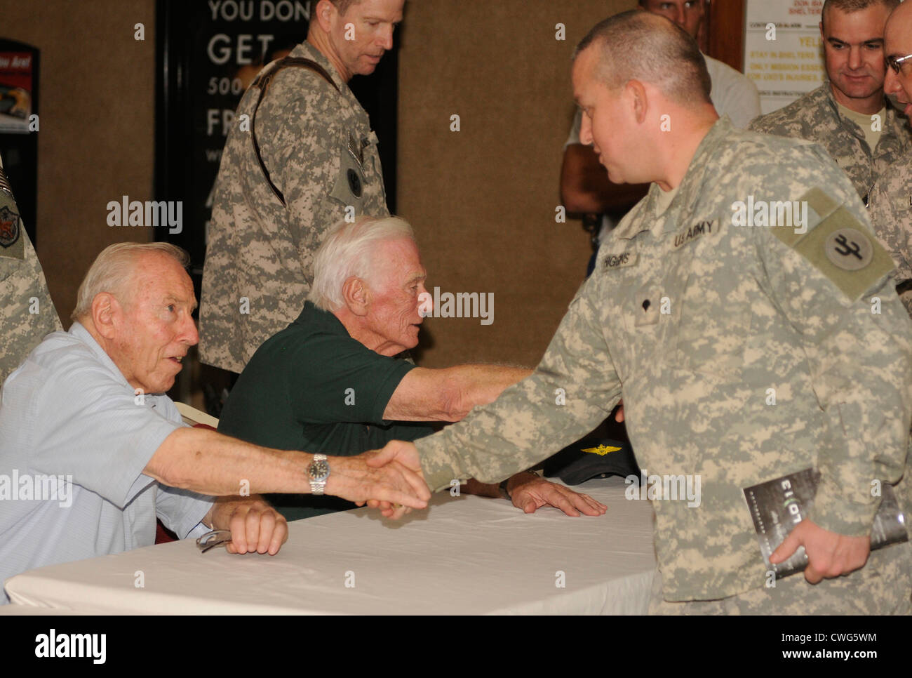Spc. Brian Higgins gets a chance to shake hands with Jim Lovell ...