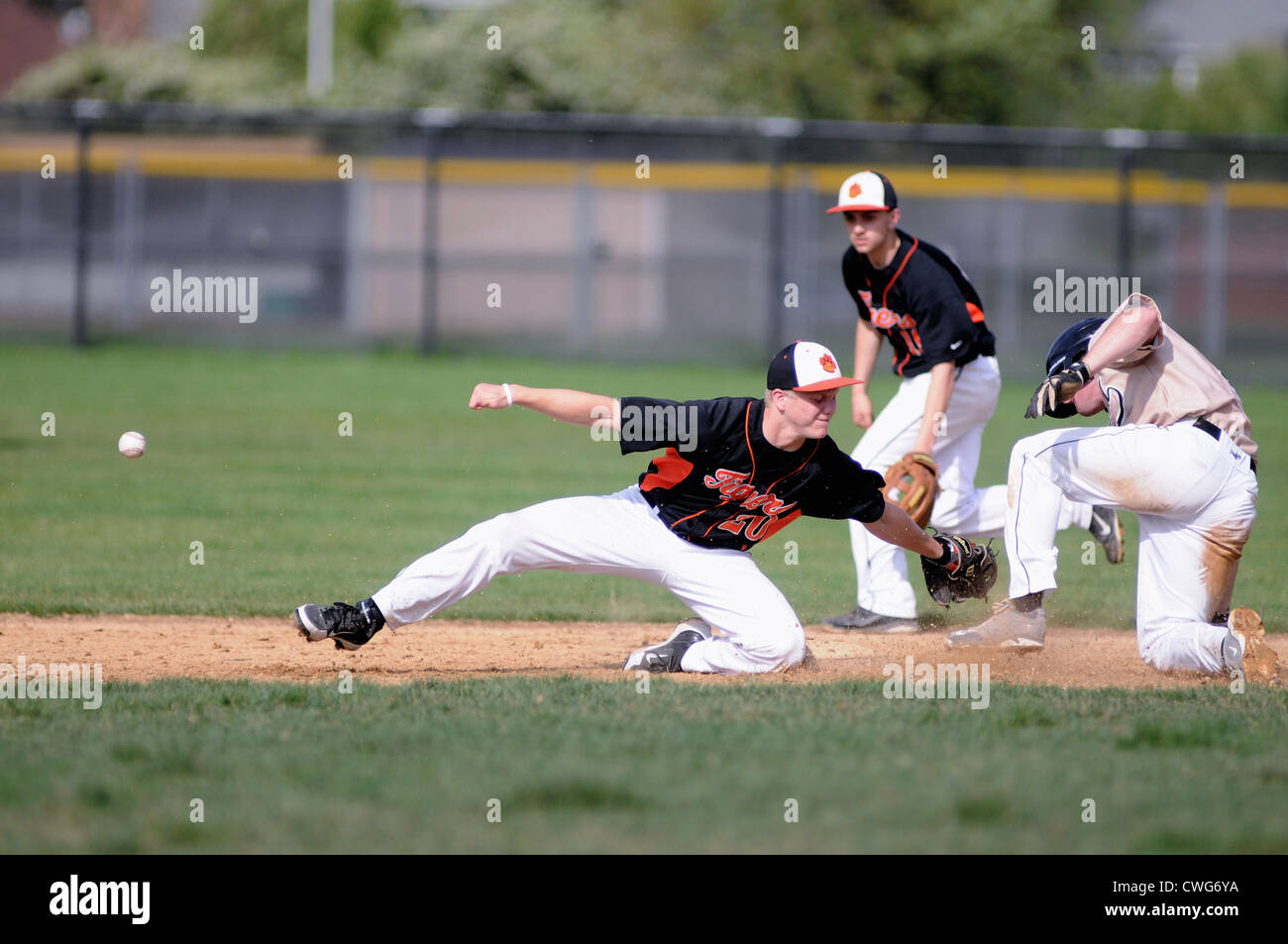 Baseball high school shortstop lunges to tag base runner at second base ...