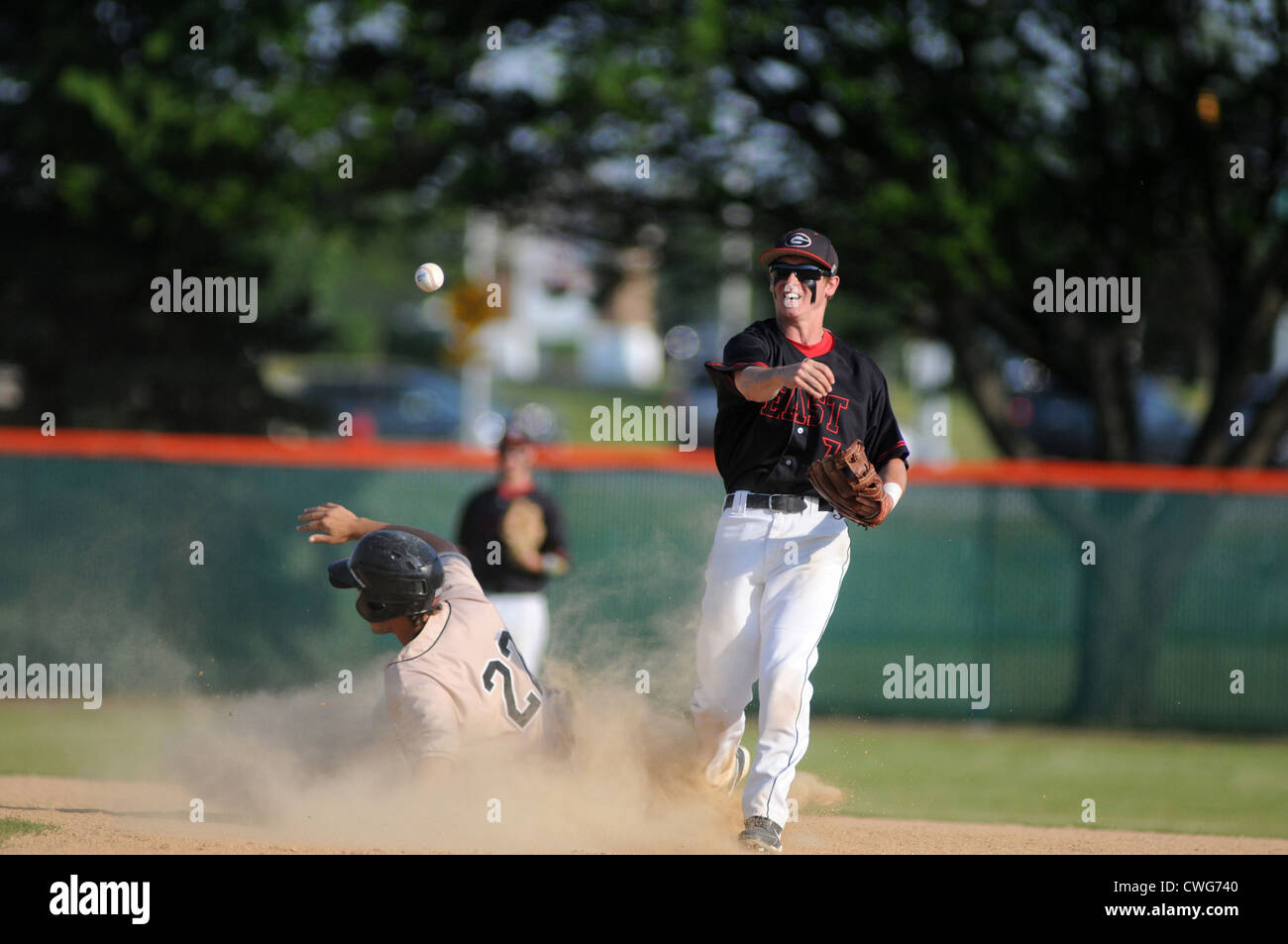 Sliding base runner is forced out at second base by shortstop making ...