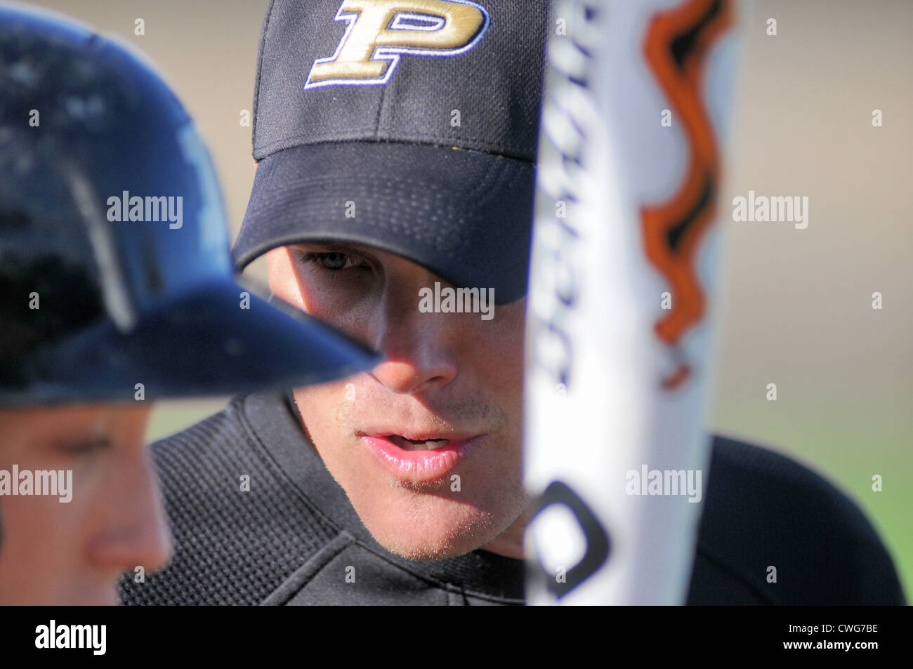 Baseball coach talking with team's next hitter during a high school ...