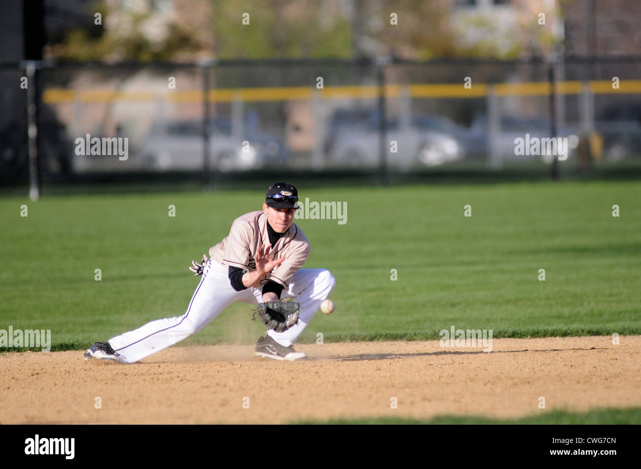 Baseball Infielder in position to field a ground ball high school game ...