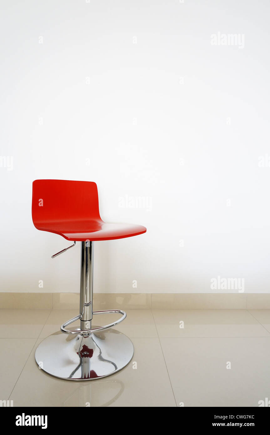 Red bar stool isolated onto white background Stock Photo - Alamy