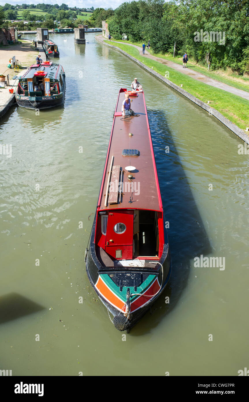 Looking down on a narrow boat about to pass under a bridge Stock Photo ...