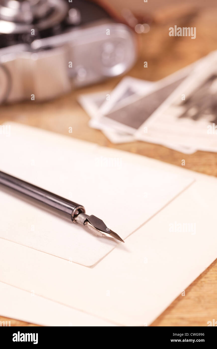 vintage ink pen, old photos and camera. tiny focus Stock Photo - Alamy