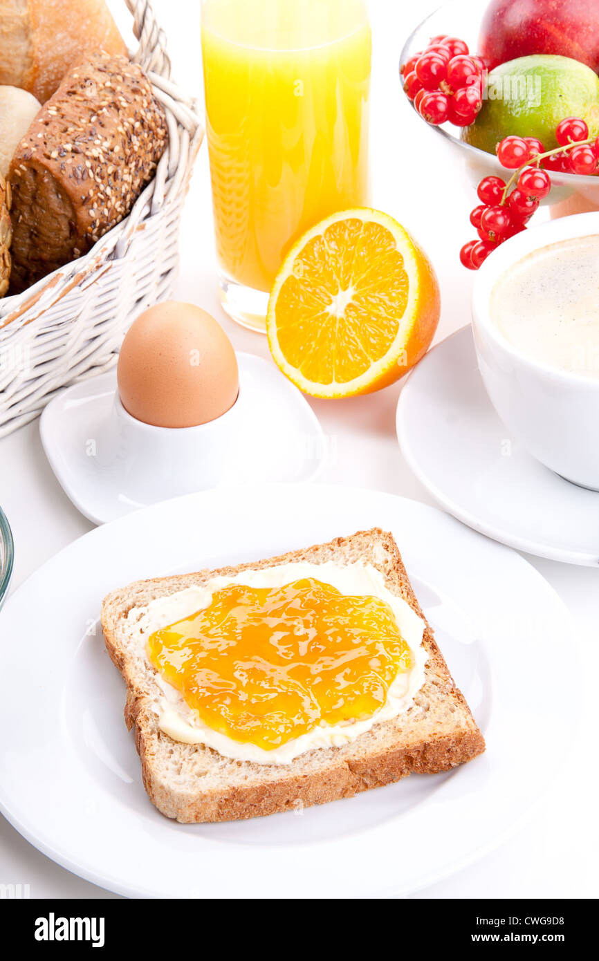 breakfast table with toast and orange marmelade isolated on white ...