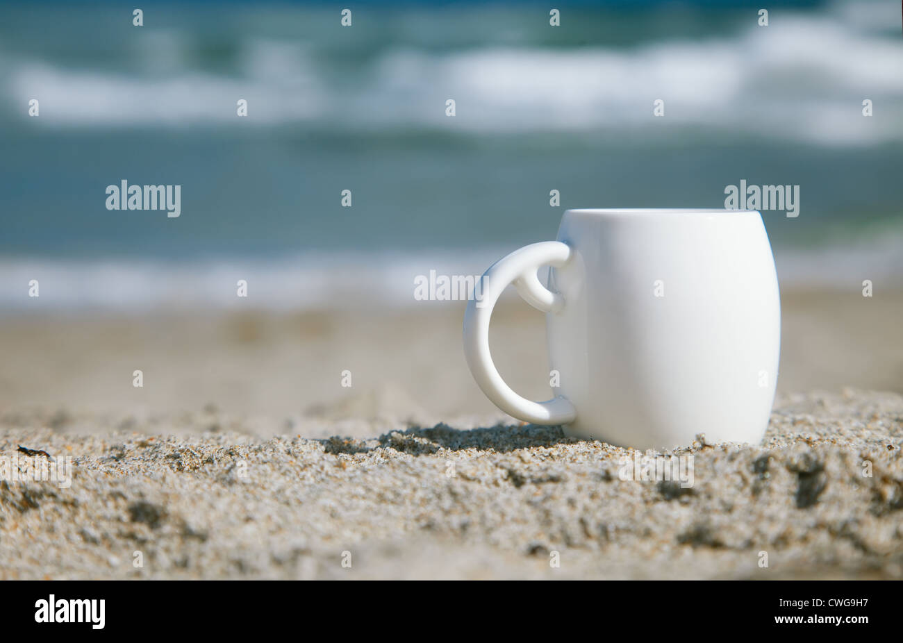 espresso coffee in white cup with ocean waves, beach and seascape ...