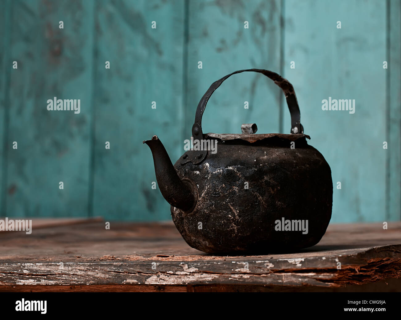 sooty old teapot on old table in open kitchen Stock Photo - Alamy