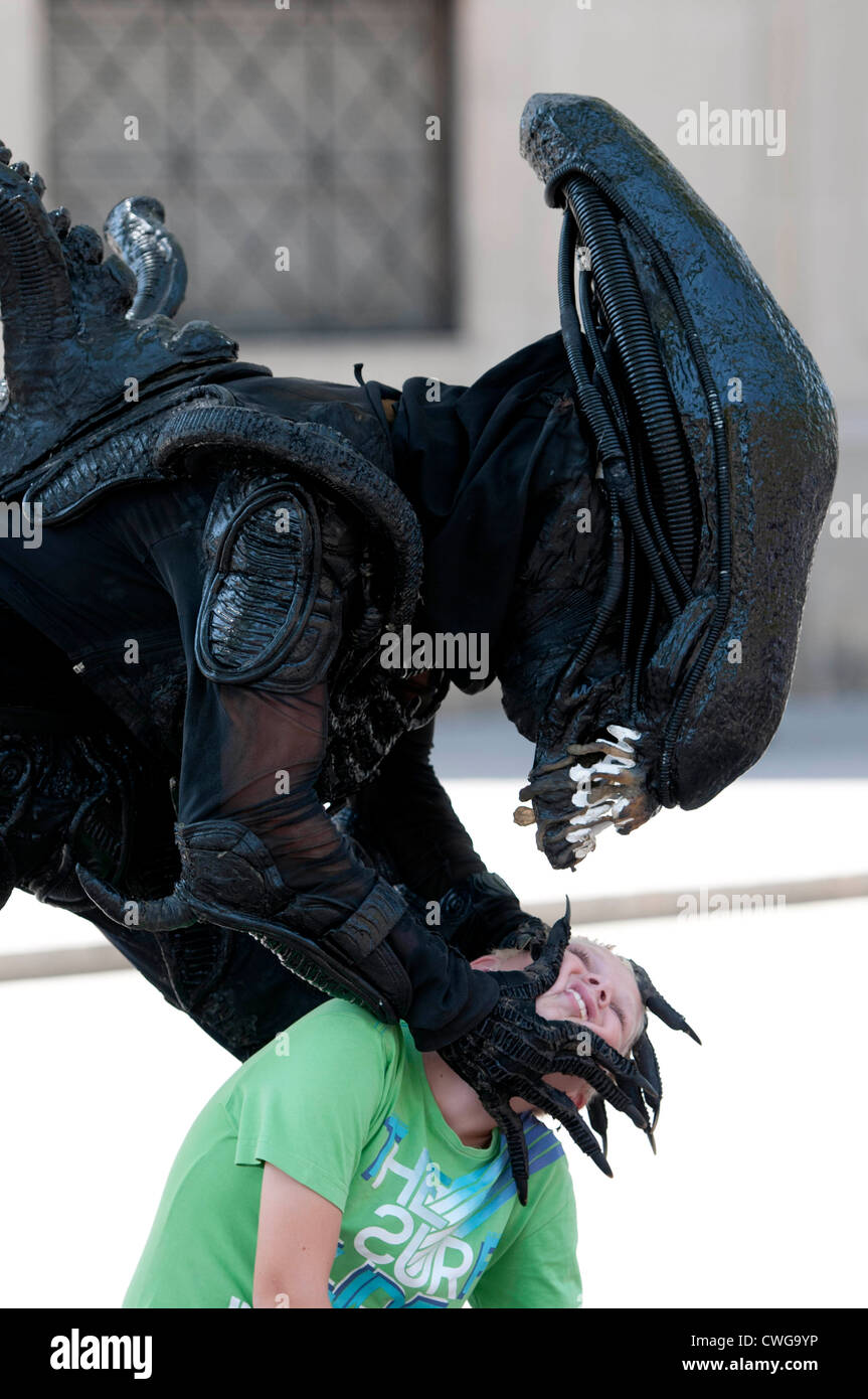 Child with "Alien" human statue in the centre of Barcelona, Spain Stock ...