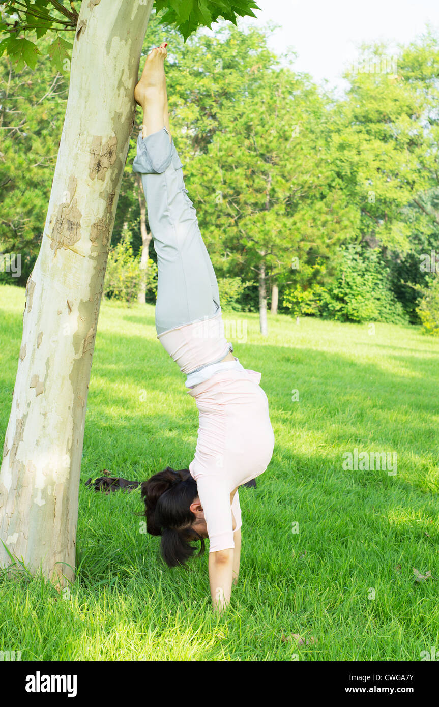 Inverted woman on the grass Stock Photo - Alamy