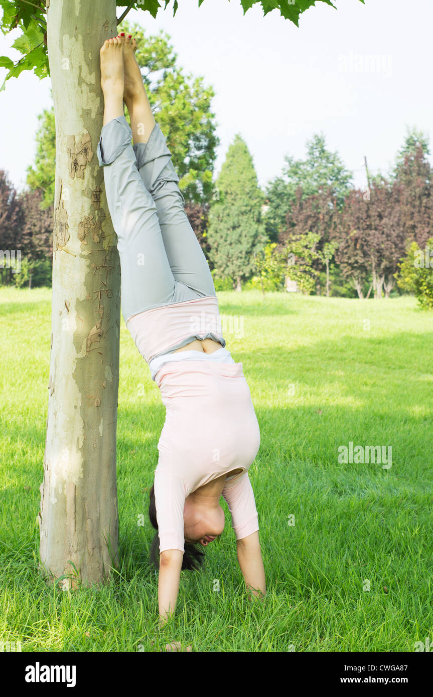 Inverted woman on the grass Stock Photo - Alamy