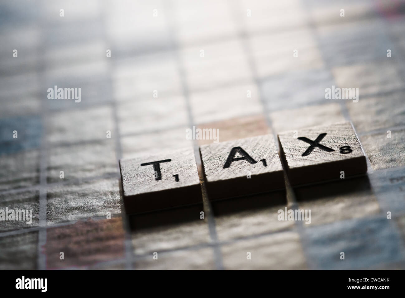 Letter tiles spelling the word TAX Stock Photo - Alamy
