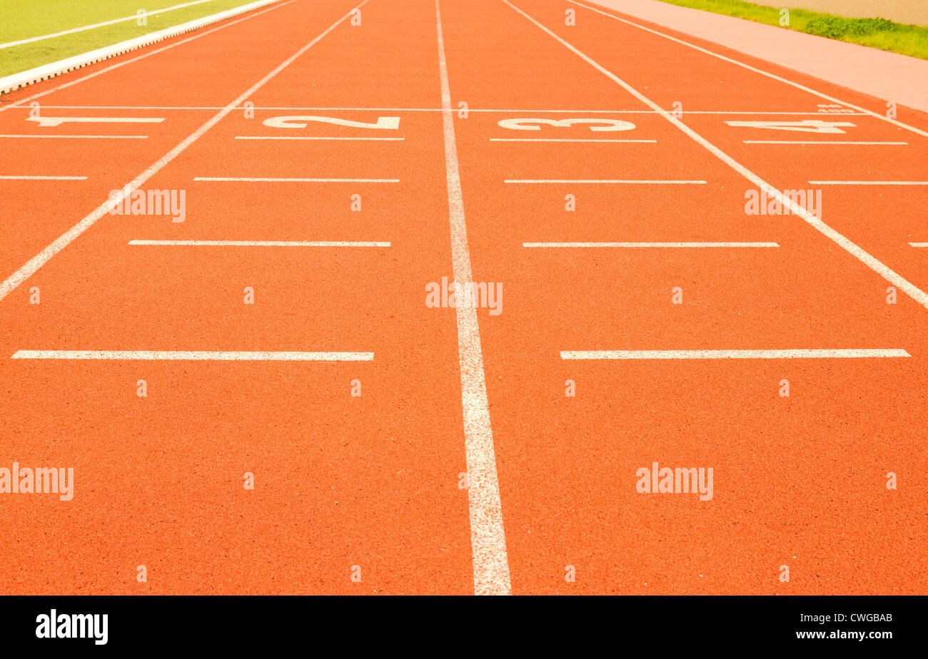 White finish line on the orange track and field tartane Stock Photo - Alamy