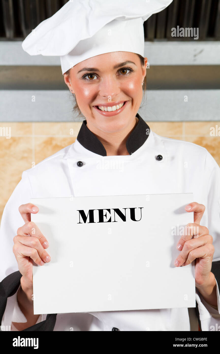 beautiful female chef holding menu in kitchen Stock Photo - Alamy