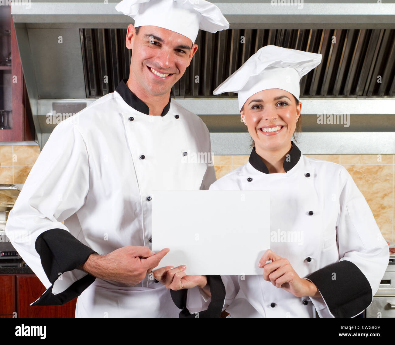 happy professional chefs holding white board in kitchen Stock Photo - Alamy