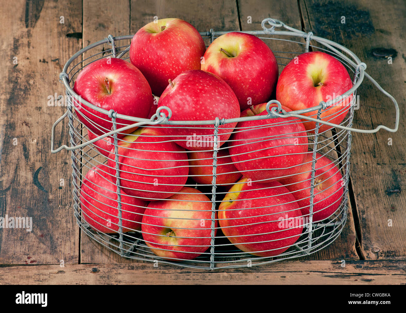 Red apples in a basket with wooden vintage background Stock Photo - Alamy