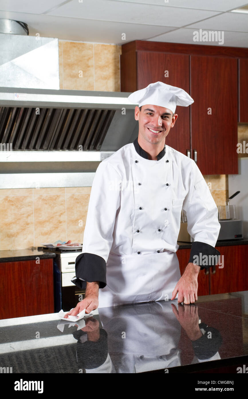 male chef cleaning commercial kitchen Stock Photo - Alamy