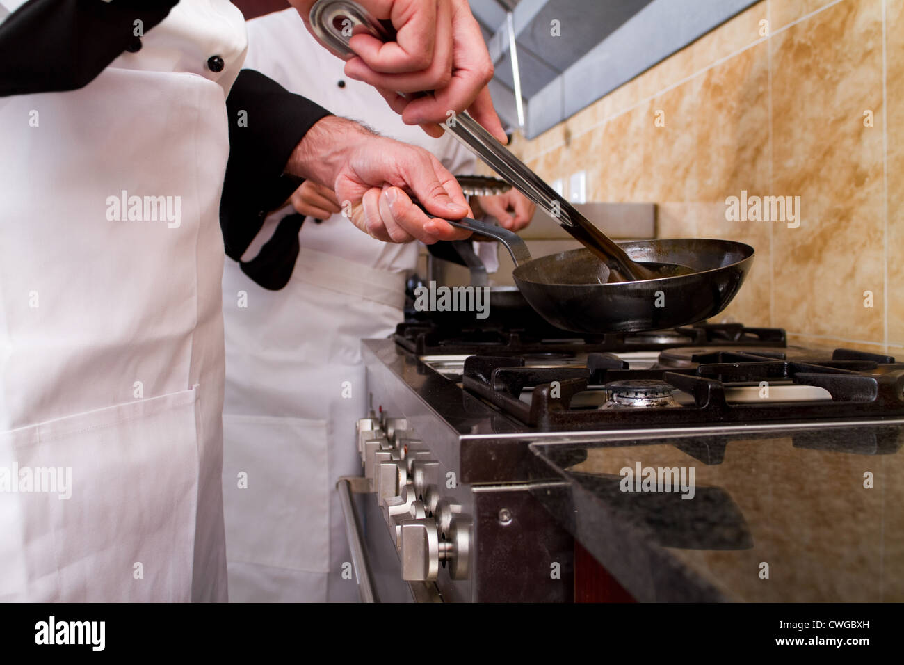 professional chefs cooking in kitchen Stock Photo - Alamy