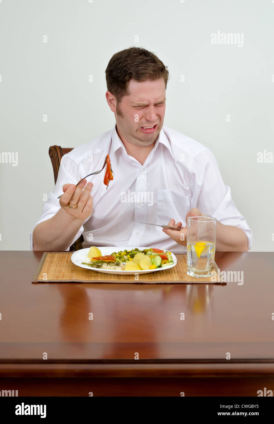 Handsome man eating fork knife hi-res stock photography and images - Alamy