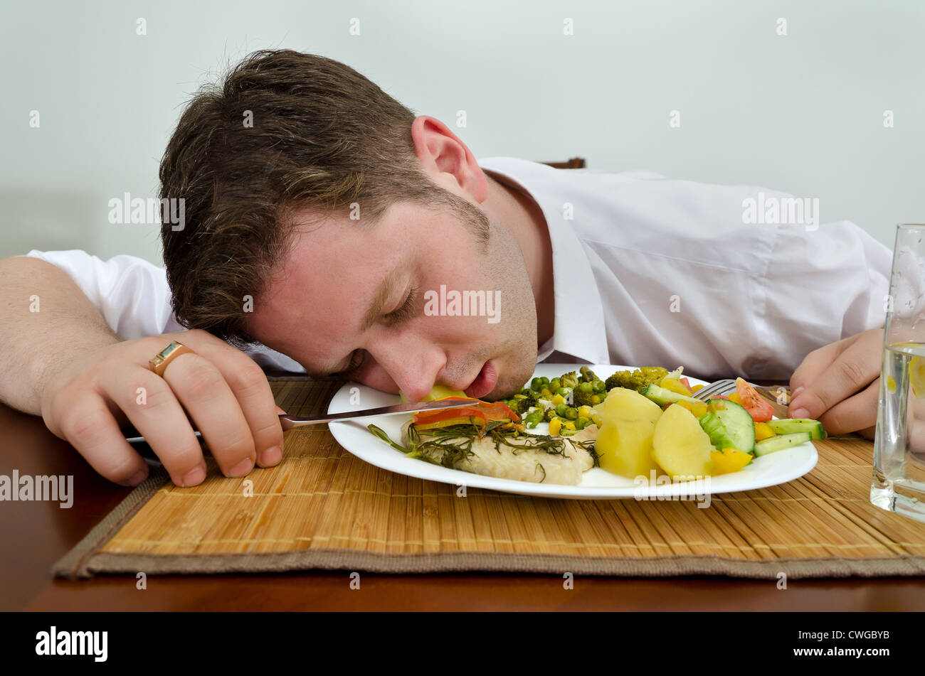 Drunk man sleeping in his dinner plate Stock Photo - Alamy